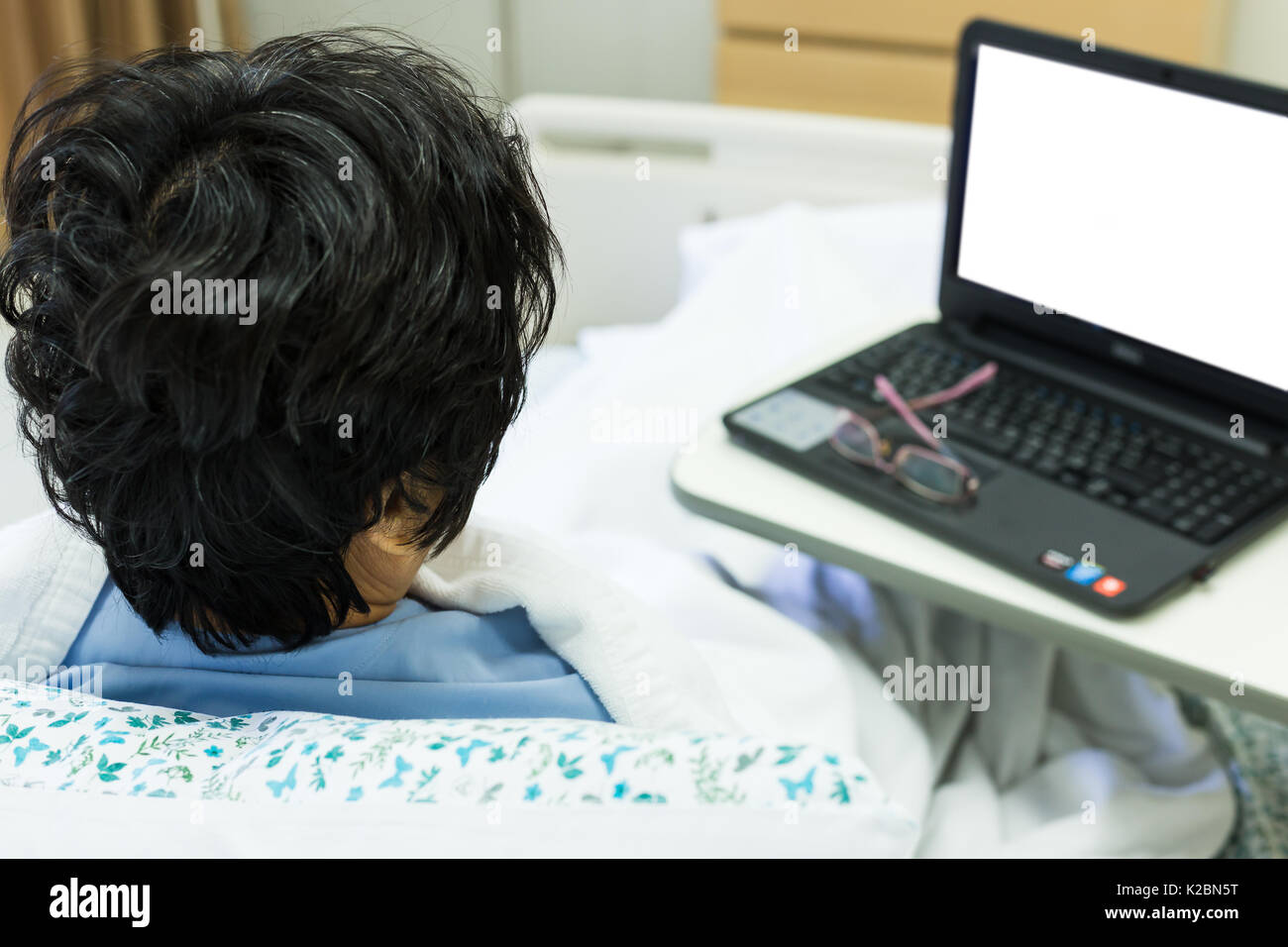 Female patient is watching computer screen for chat with children or ...