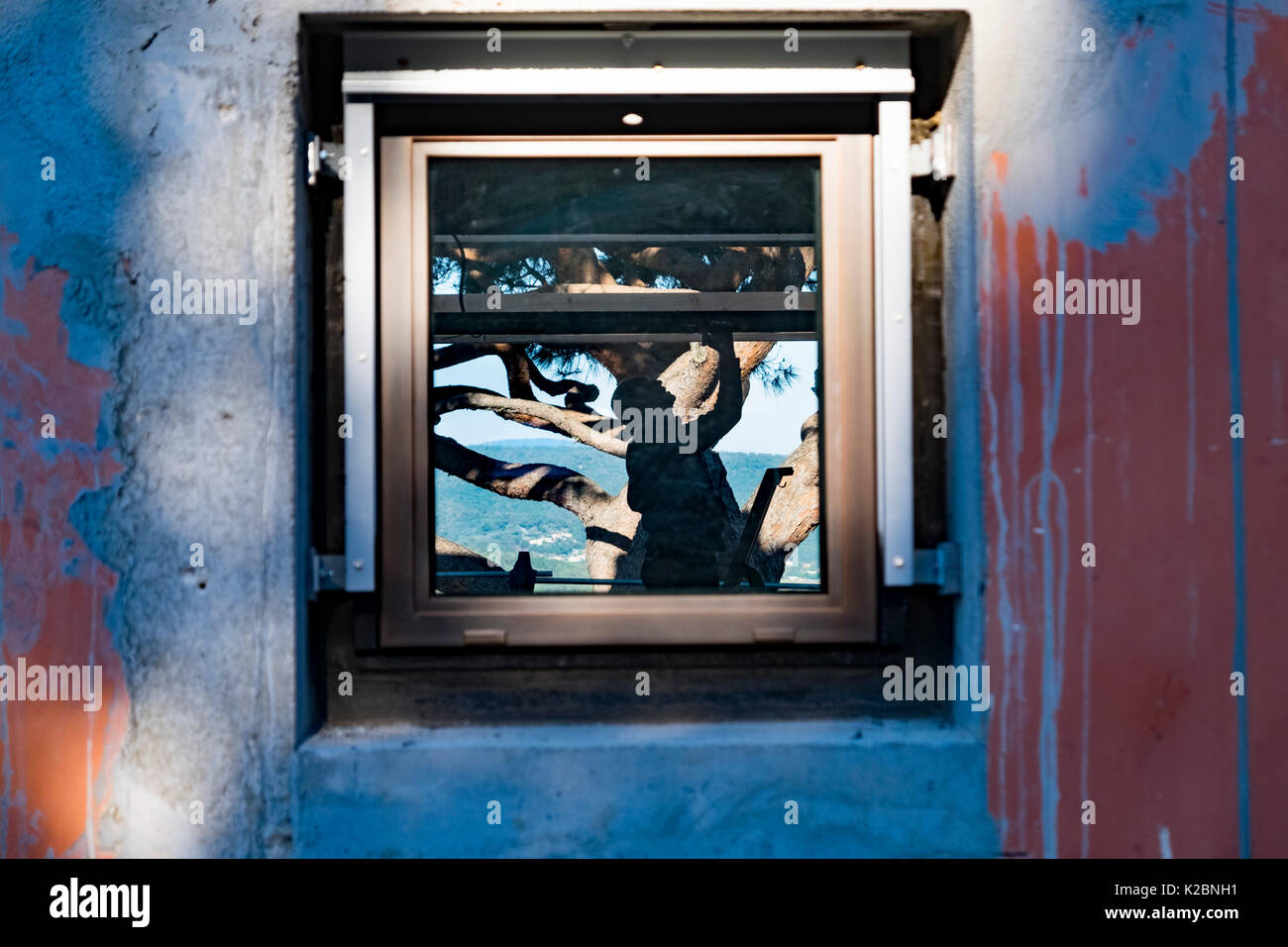 Construction worker's shadow through a window of a new home being built ...