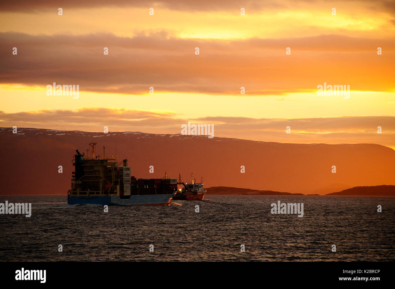 Cargo ship sailing through the Beagle Channel at sunset. Tierra del ...