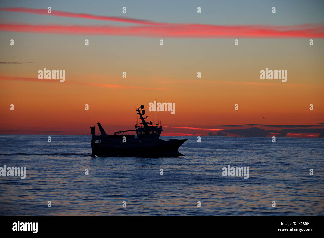 Fishing vessel ocean harvest at dawn on calm august morning hi-res ...