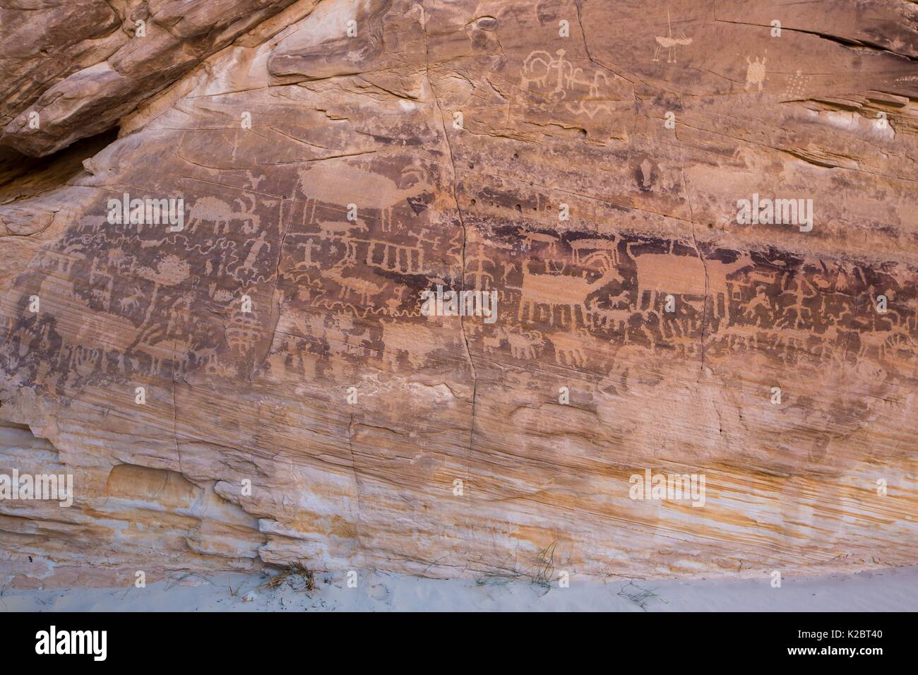 Native American petroglyph rock art is carved into the Aztec sandstone ...