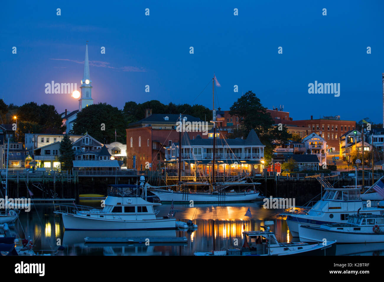 Camden harbour at twilight, with small boats docked, Maine, USA, August ...