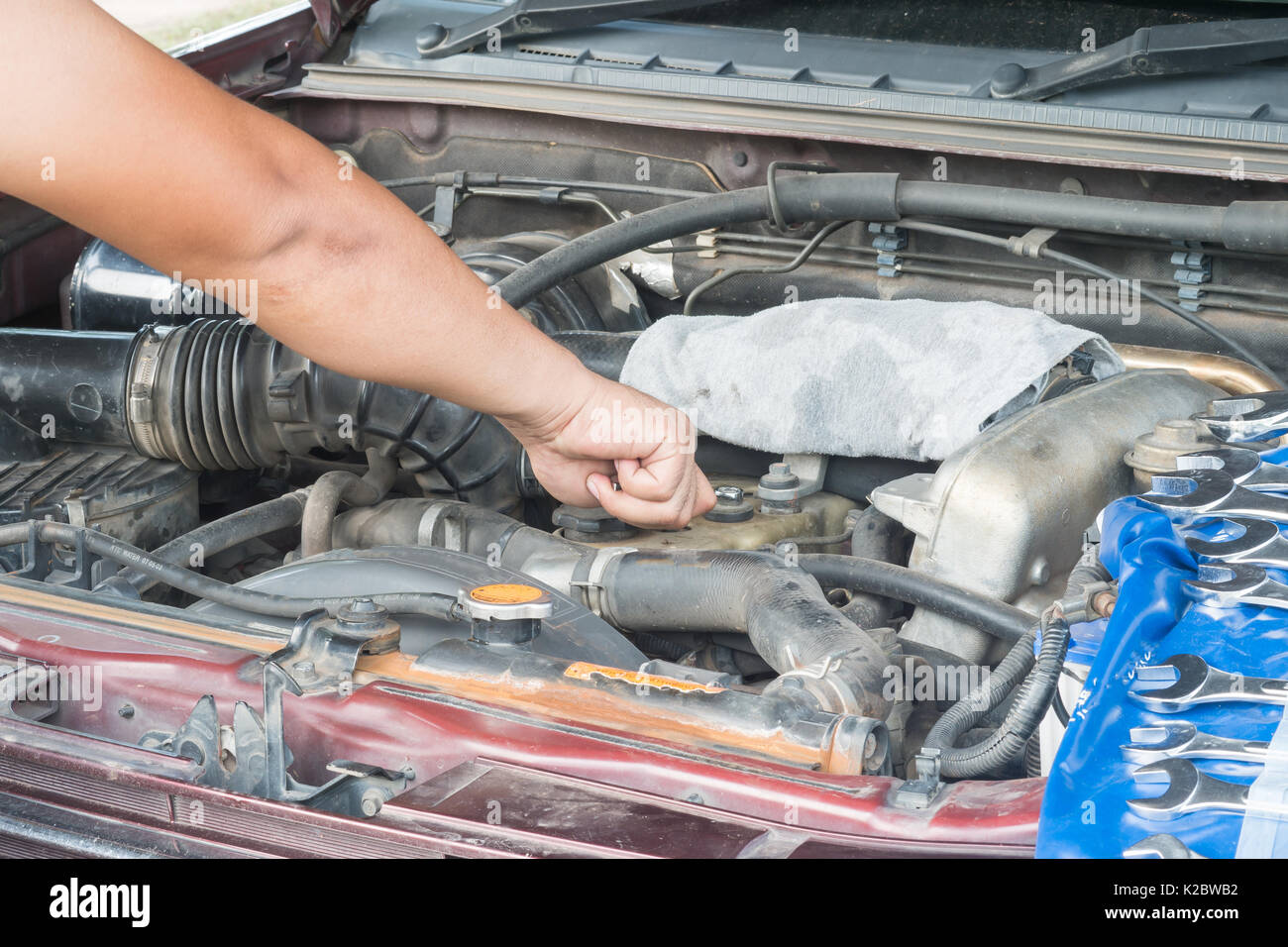Hands repairing a modern car engine with a wrench Stock Photo - Alamy