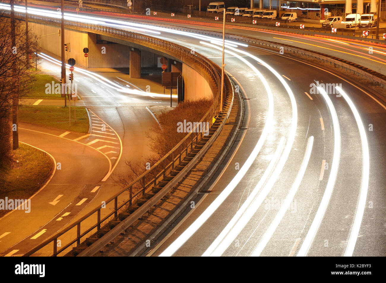 Car lights on a german highway construction site with signs at night ...
