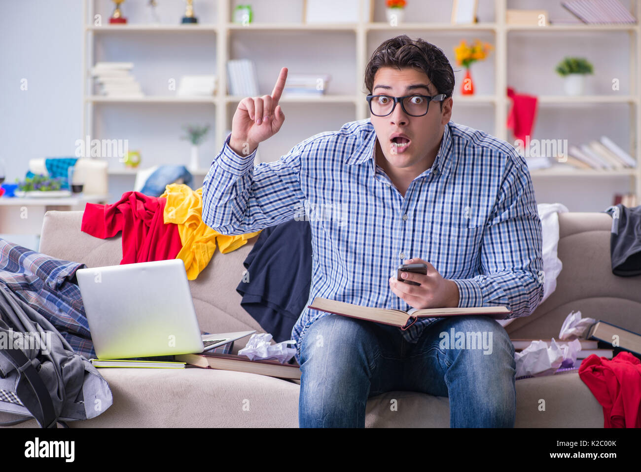 Young man working studying in messy room Stock Photo - Alamy