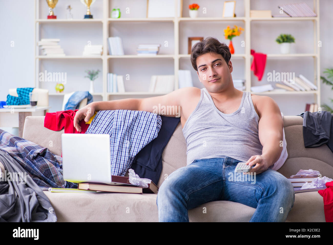 Young man working studying in messy room Stock Photo - Alamy