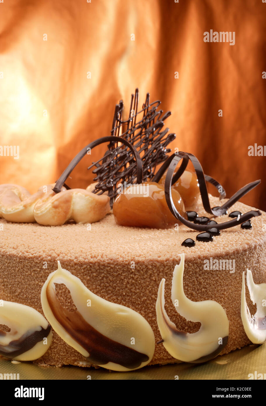 A decorated chestnut cake isolated on orange background Stock Photo - Alamy
