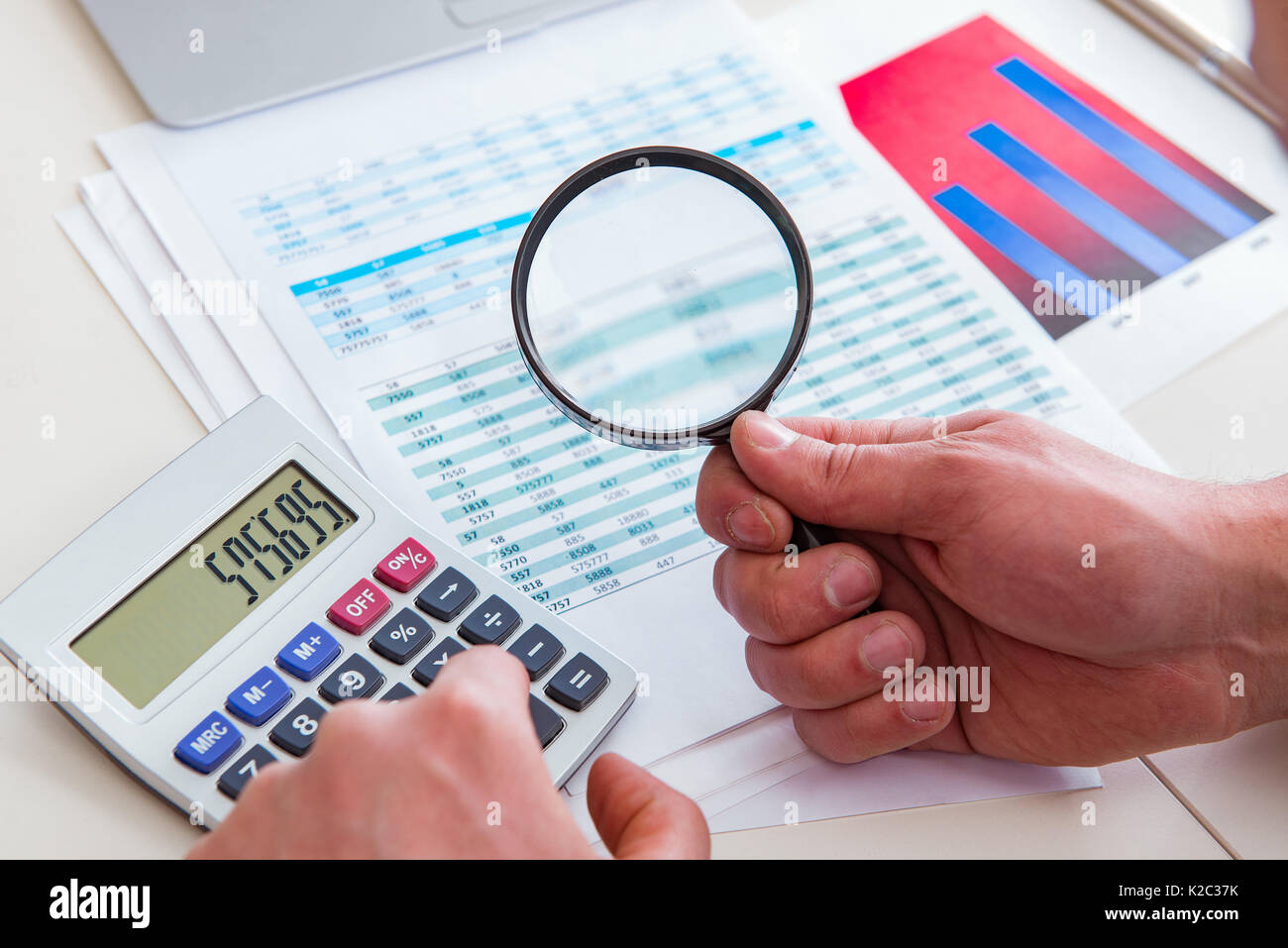 Financial reports calculator magnifying hi-res stock photography and ...