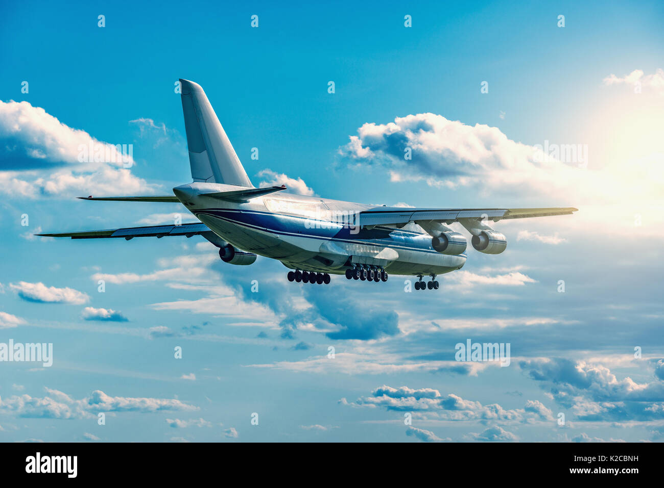 Flight of the big cargo airliner at sunny day time Stock Photo - Alamy