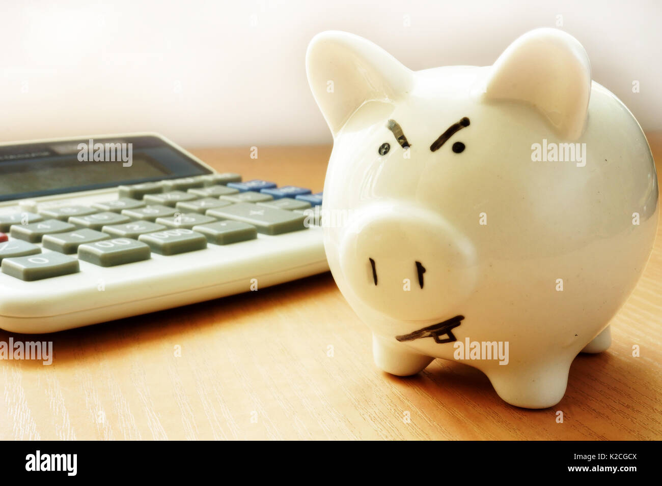 Angry piggy bank. Problems with savings Stock Photo - Alamy