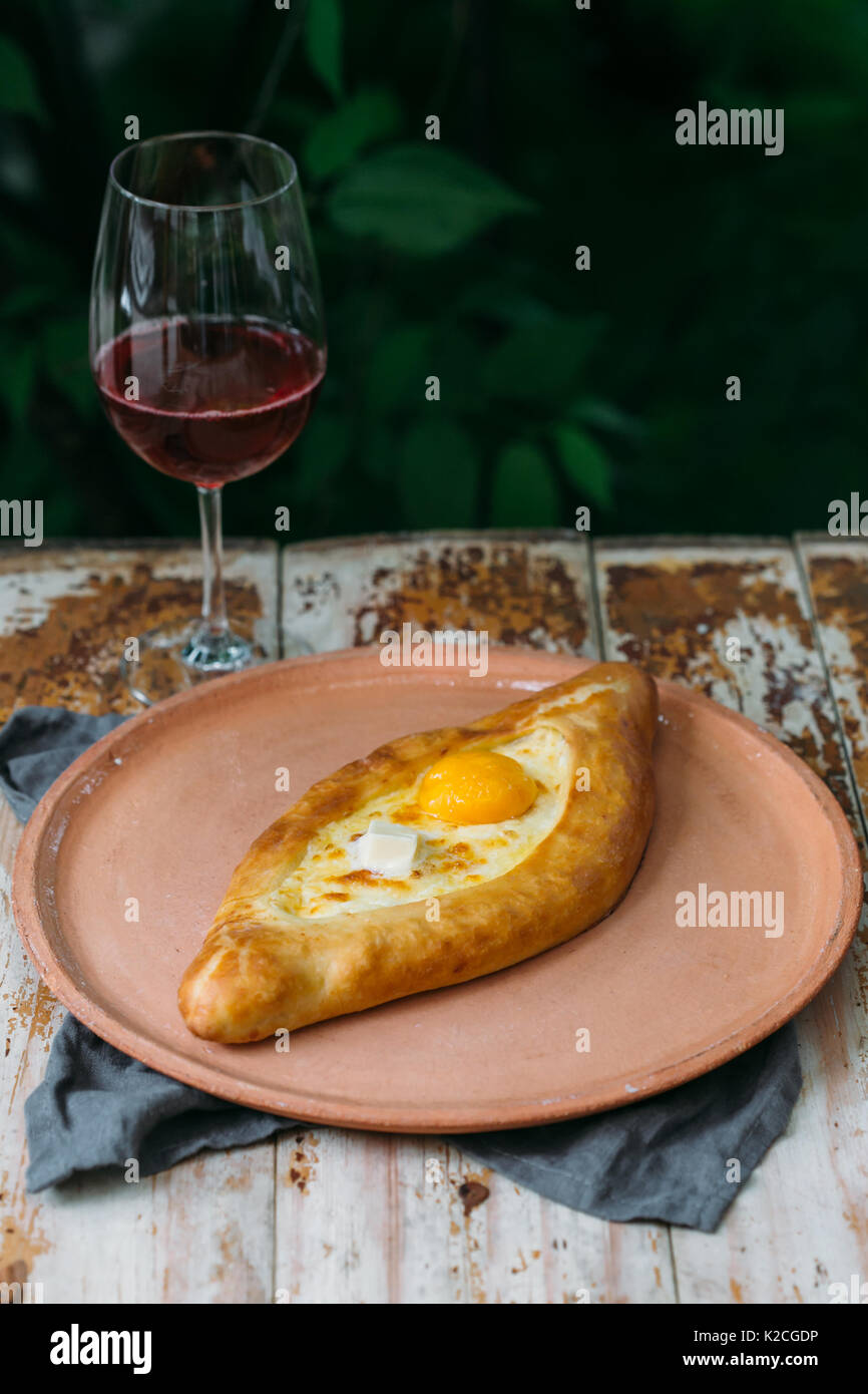 Traditional georgian lunch or dinner of khachapuri and wine served on ...