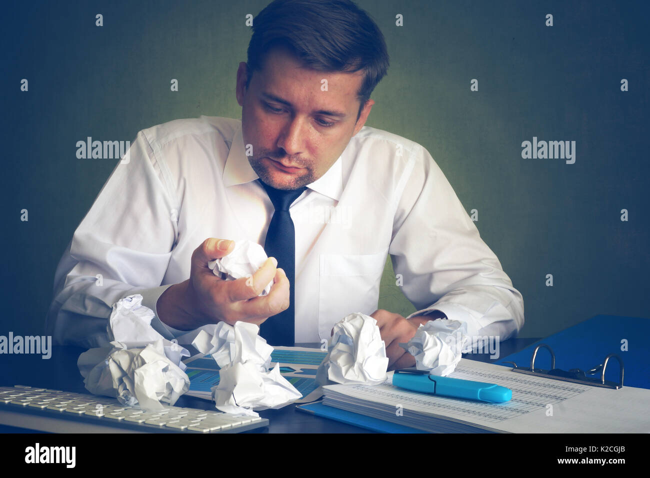 Man looking on a crumpled office paper in an office. Businessman with ...