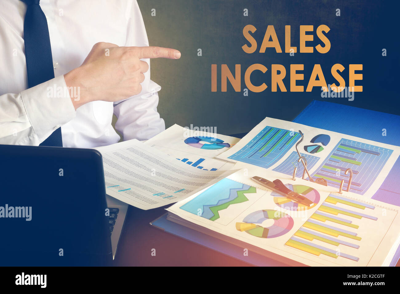 Businessman pointing at sign sales increase Stock Photo - Alamy
