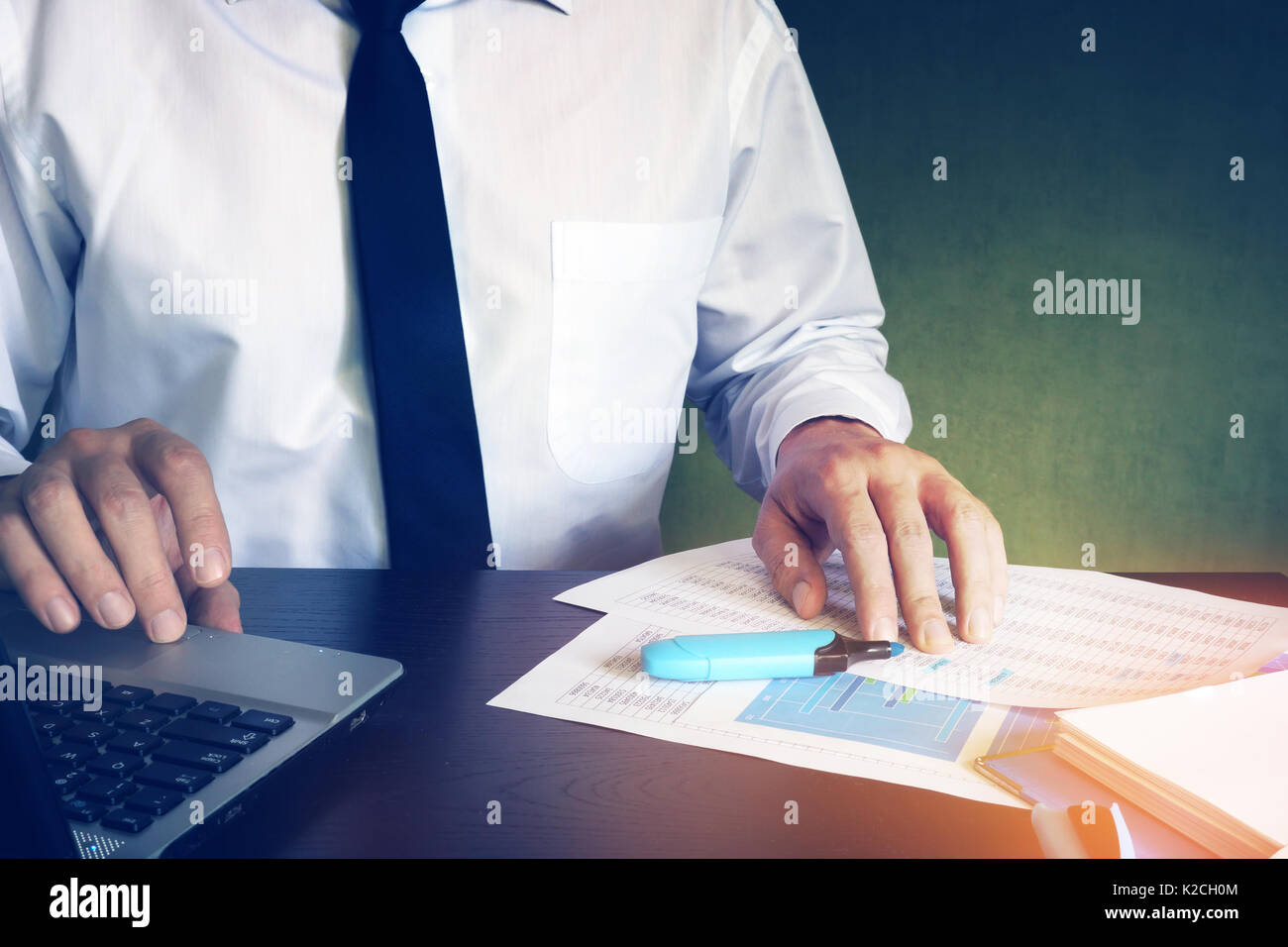 Man checking in laptop financial data and payment documents Stock Photo ...