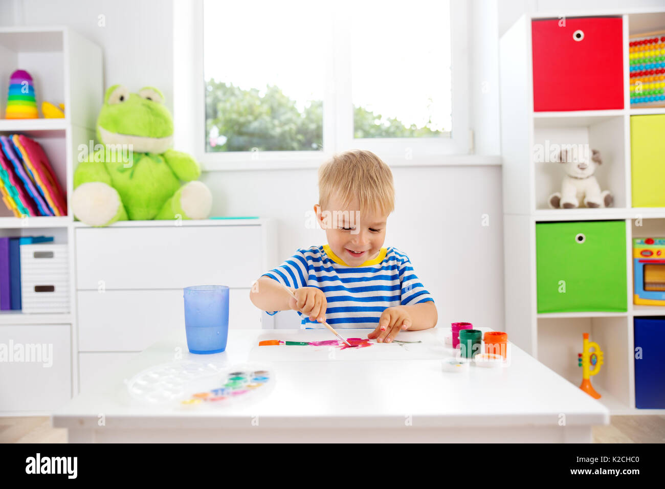 Little child drawing on the paper Stock Photo - Alamy