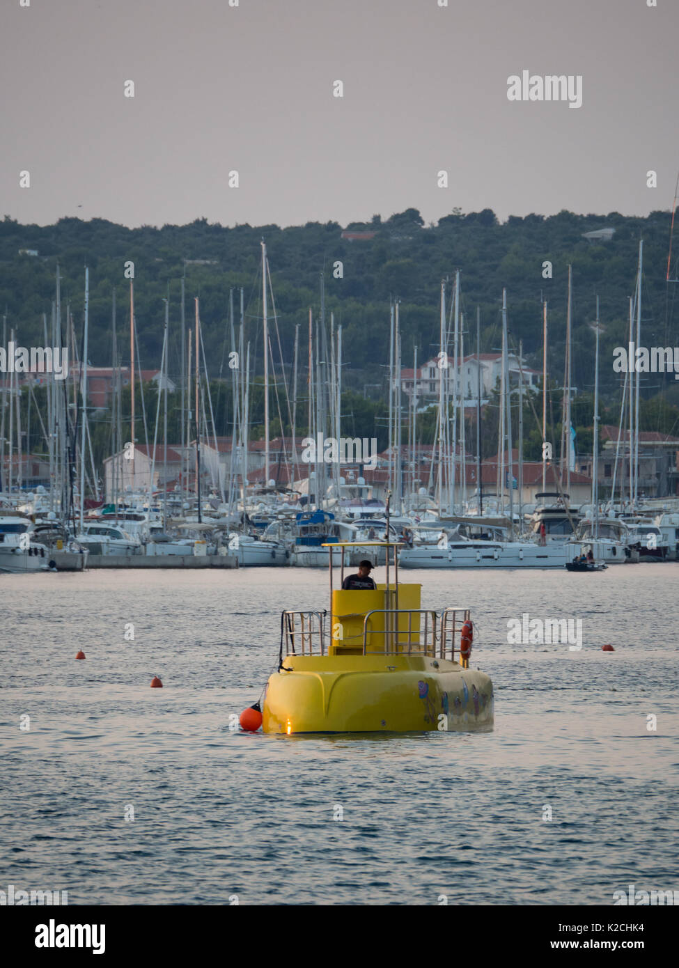 a small yellow submarine floating i harbor harbour marina sea water ...