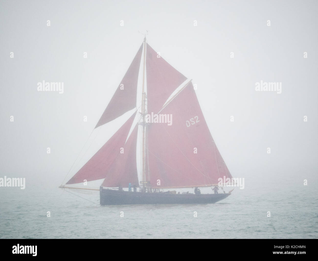 a single wooden pilot cutter classic yacht boat red sails sailing on ...