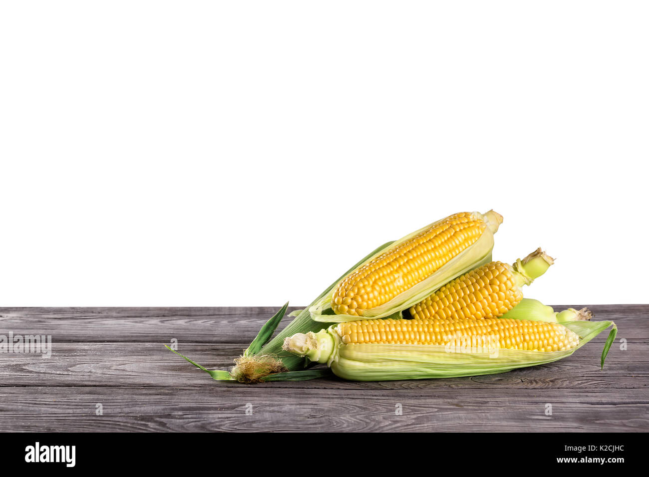 Corn on wooden table isolated on white background. The concept of a ...