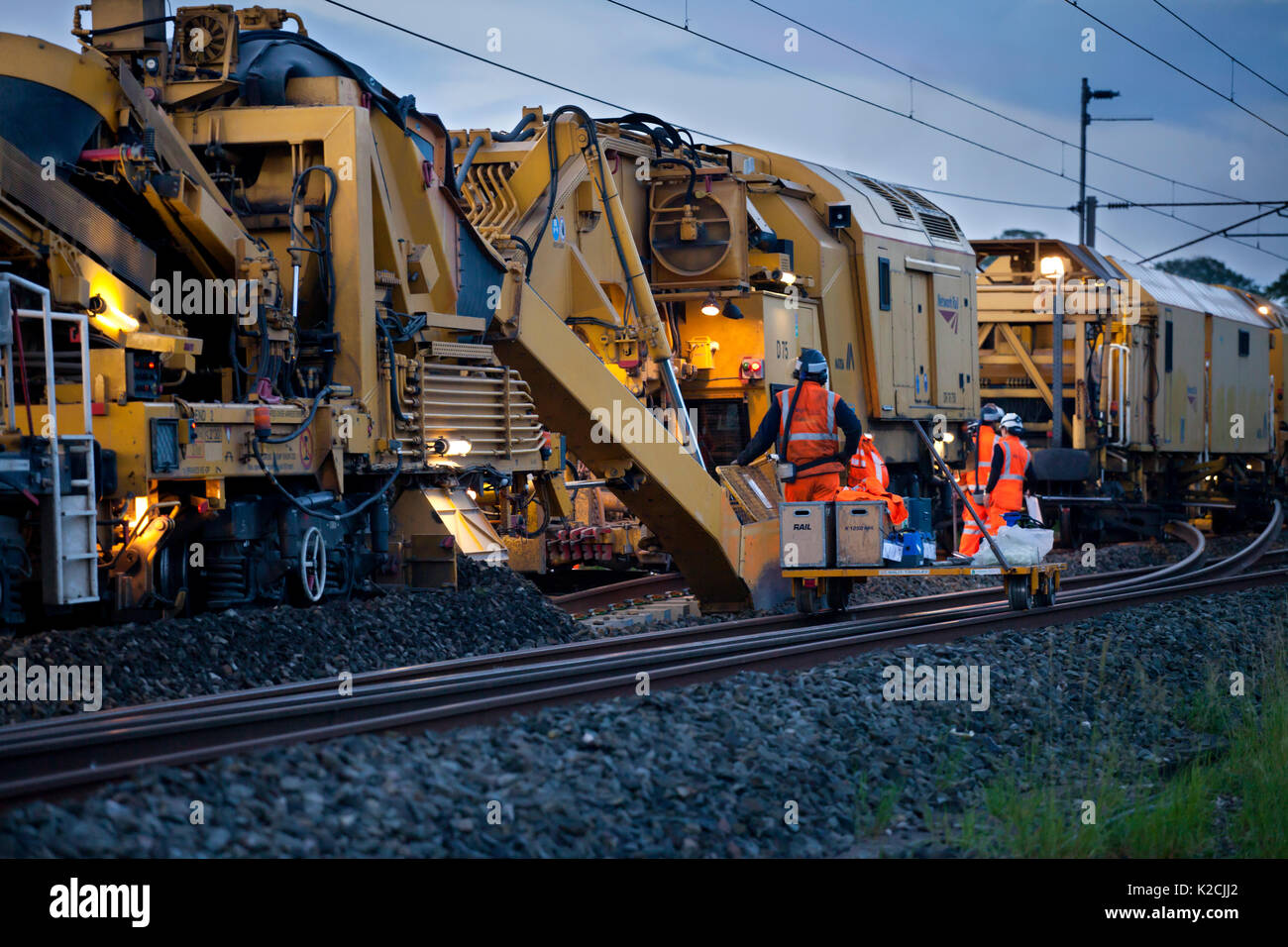 Workmen waiting for rails to be welded before completing last piece of ...
