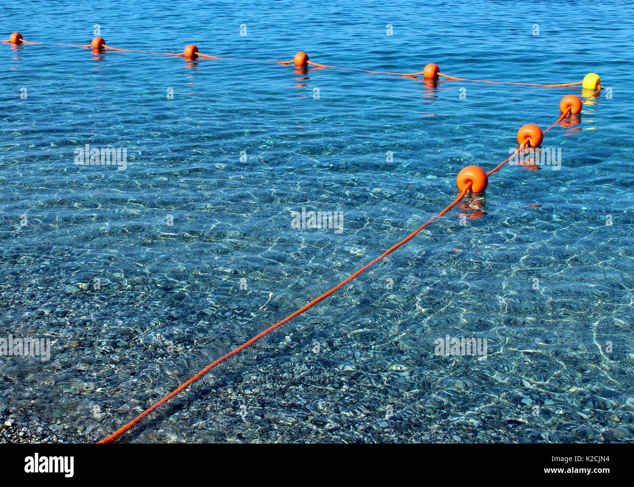 Buoys floating on transparent sea water Stock Photo - Alamy