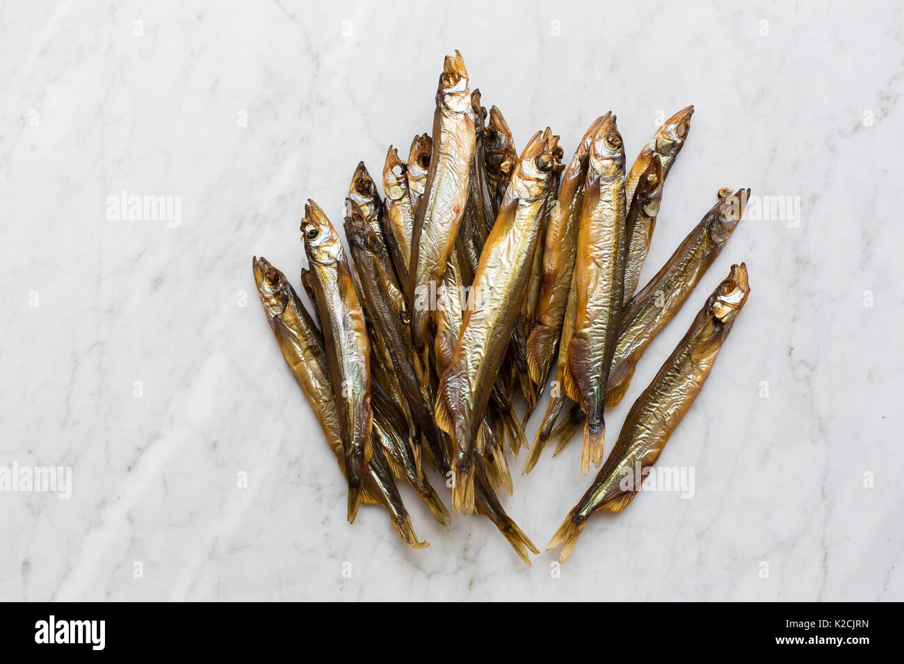 Smoked capelin isolated on a white background. Smoked capelin on marble ...