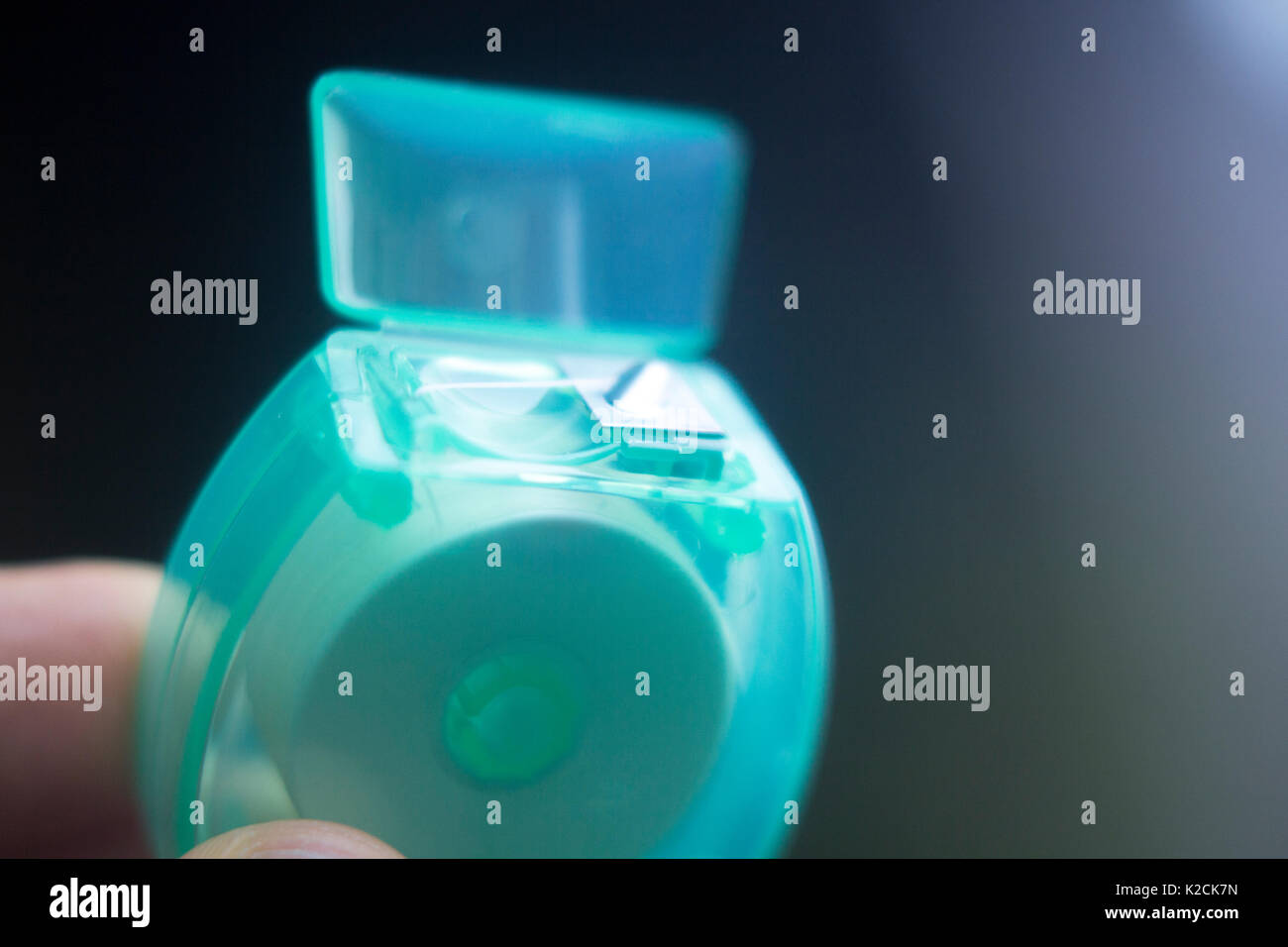 Dental floss tape closeup on plain background Stock Photo - Alamy