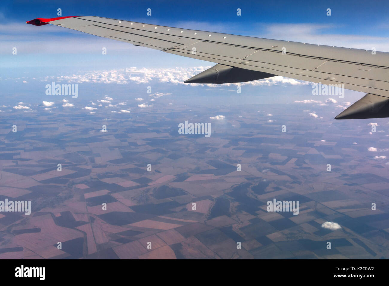 Aerial view out of window of plane which flies above the earth surface ...