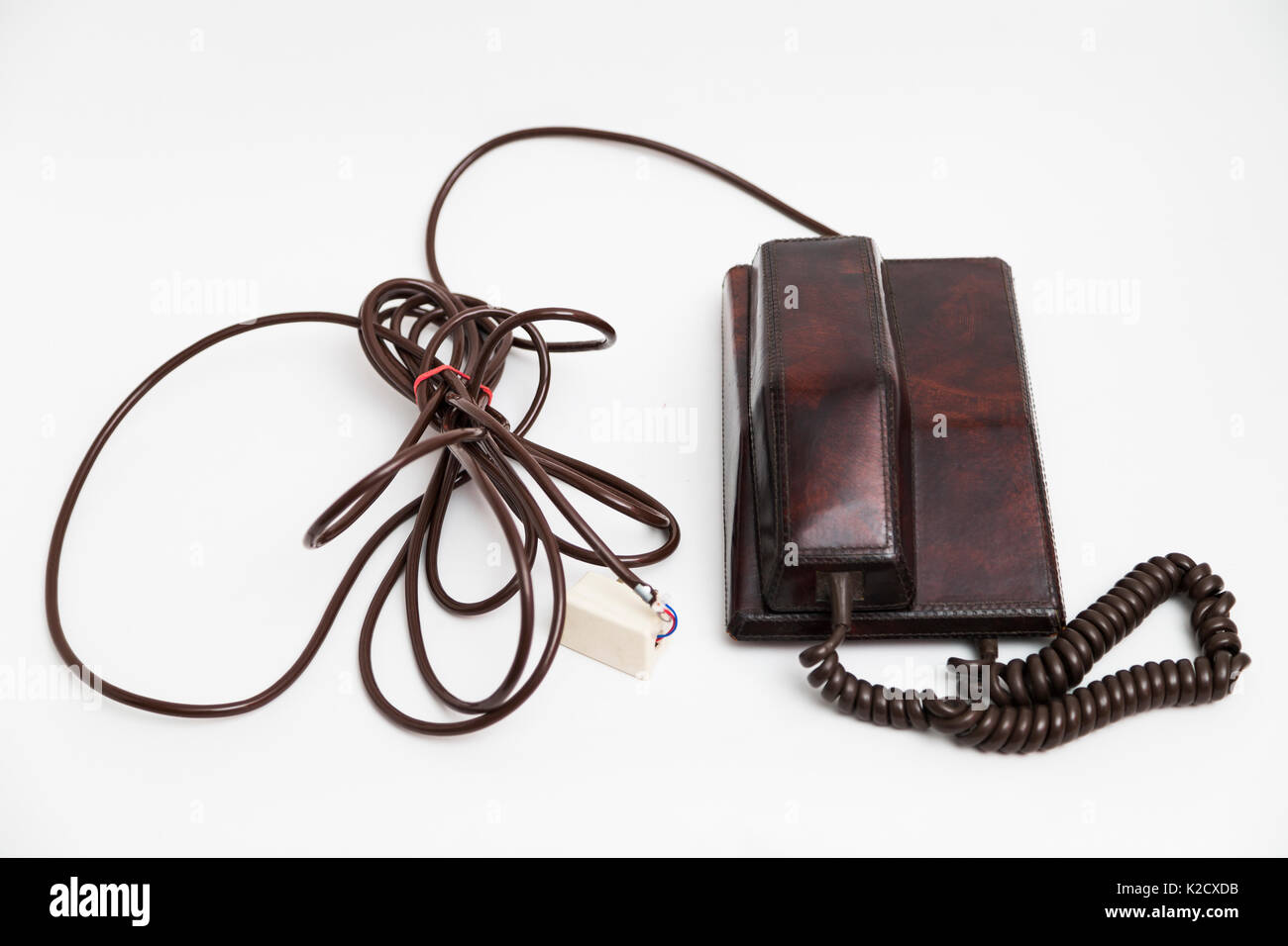 Old vintage stationary shiny leather brown plastic telephone with round ...