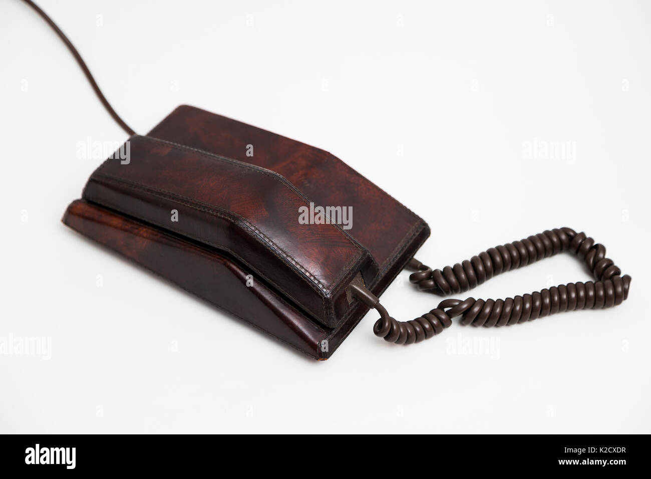 Old vintage stationary shiny leather brown plastic telephone with round ...