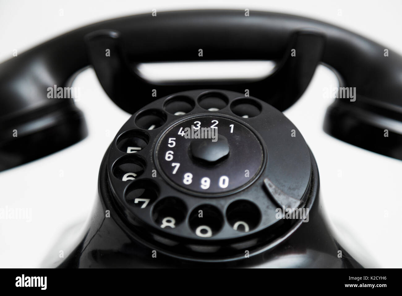 Old vintage stationary shiny black plastic telephone with round dial ...