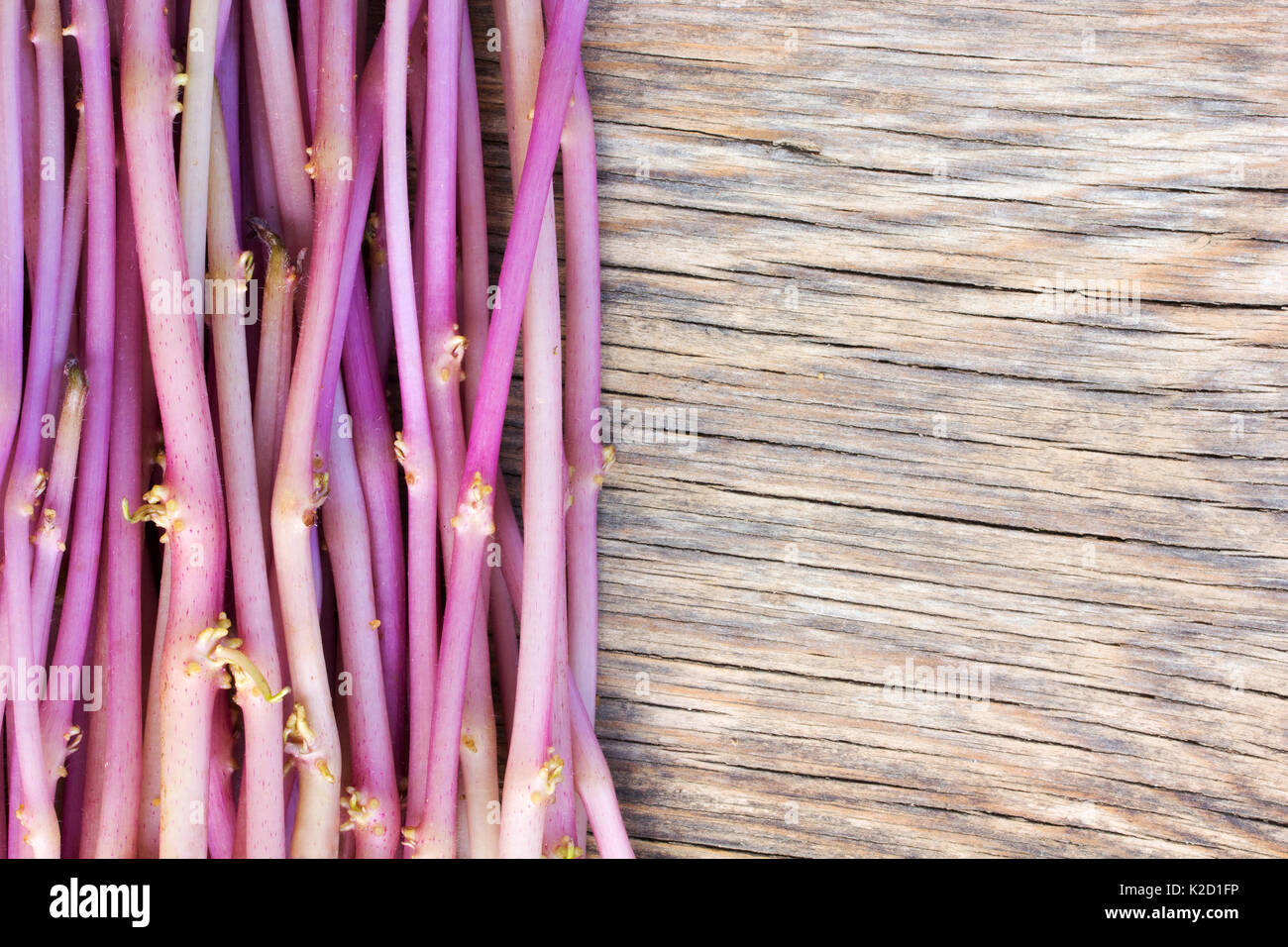 background texture purple potato sprout on an old wooden board with ...