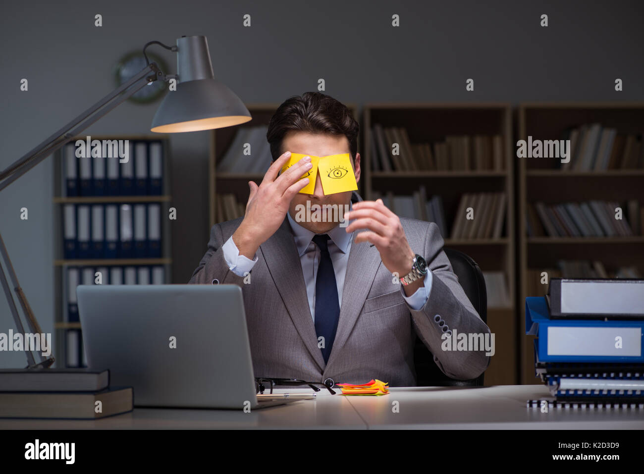 Businessman staying late to sort out priorities Stock Photo - Alamy