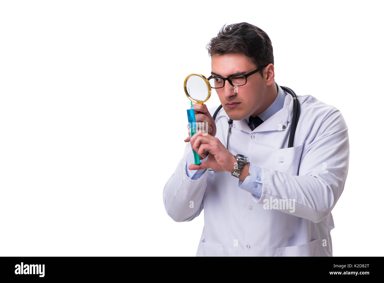 Young doctor with a magnifying glass and a syringe isolated on white ...