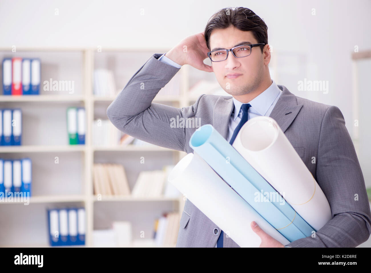 Businessman engineer draftsman with blueprints drawings Stock Photo - Alamy