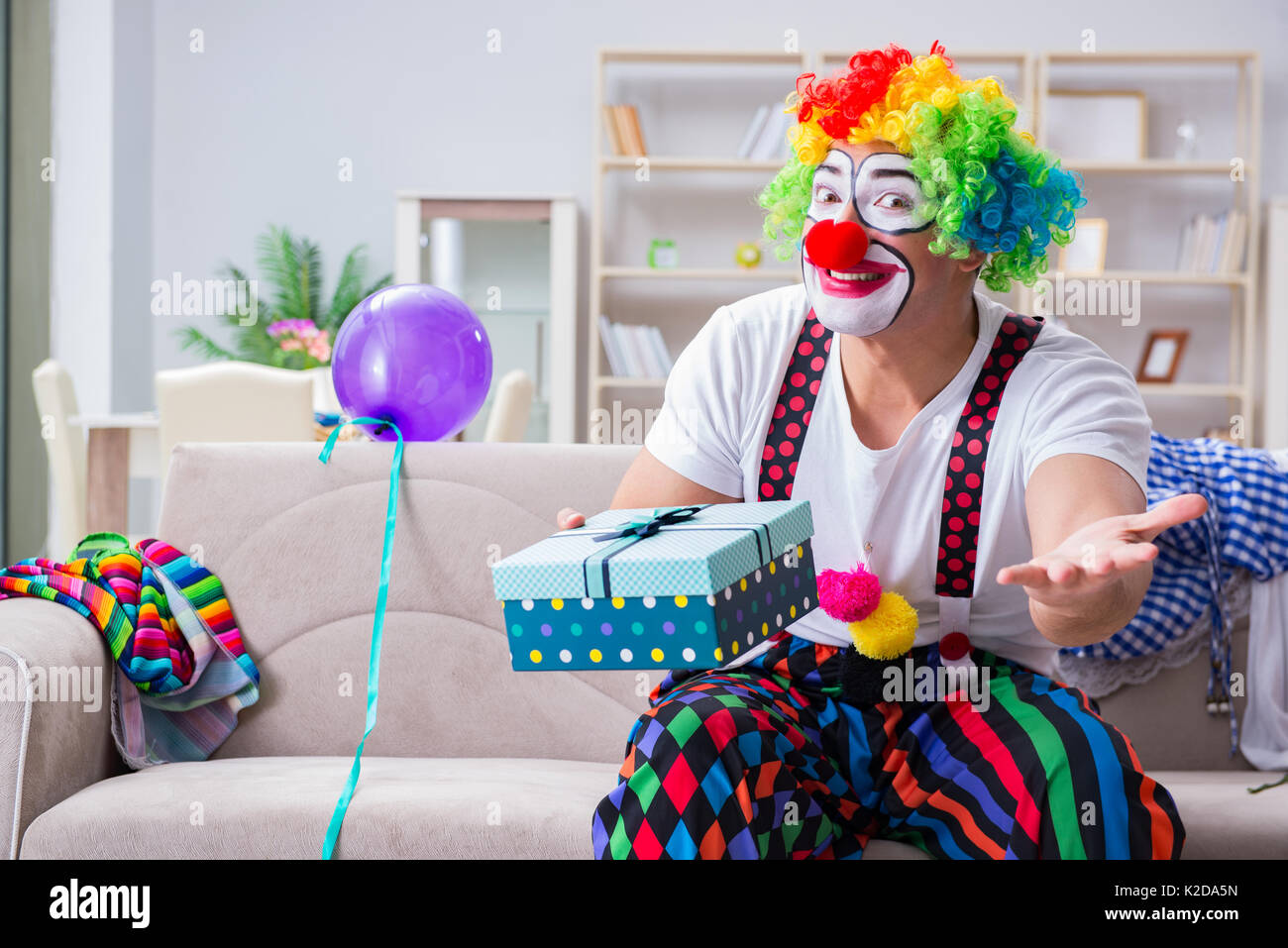 Drunk clown celebrating having a party at home Stock Photo - Alamy
