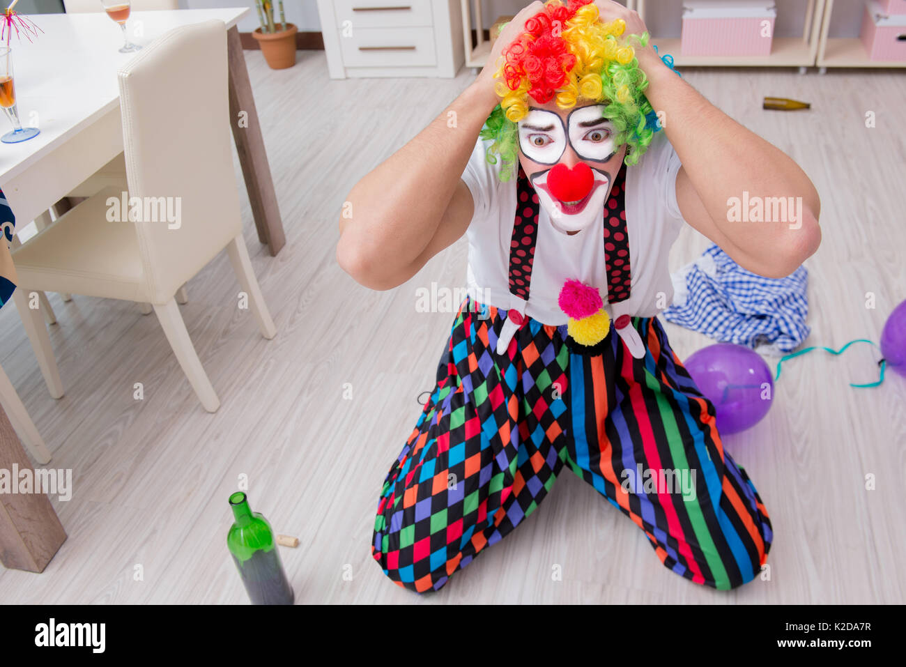 Drunk clown celebrating having a party at home Stock Photo - Alamy