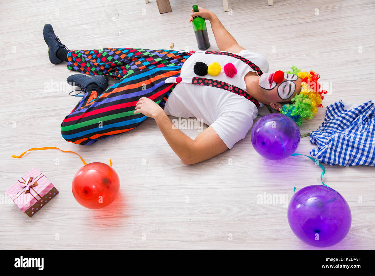 Drunk clown celebrating having a party at home Stock Photo - Alamy