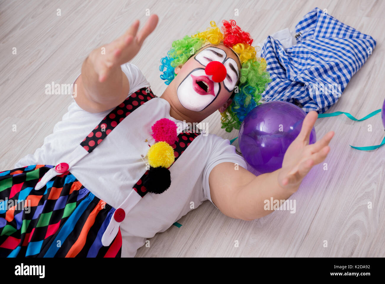 Drunk clown celebrating having a party at home Stock Photo - Alamy