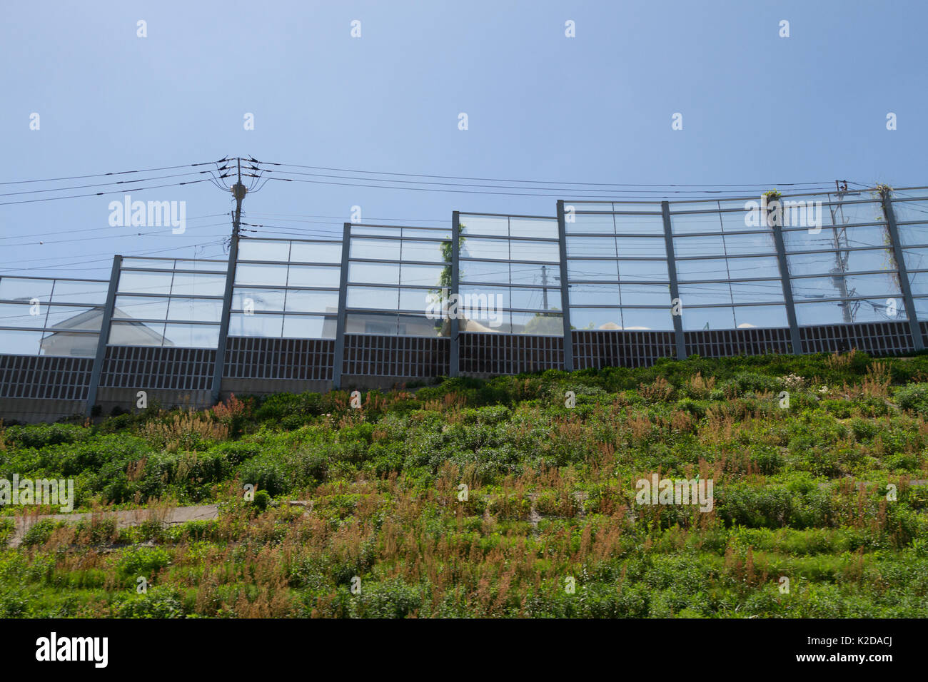 Soundproofing glass walls along the side of an expressway in Miura ...