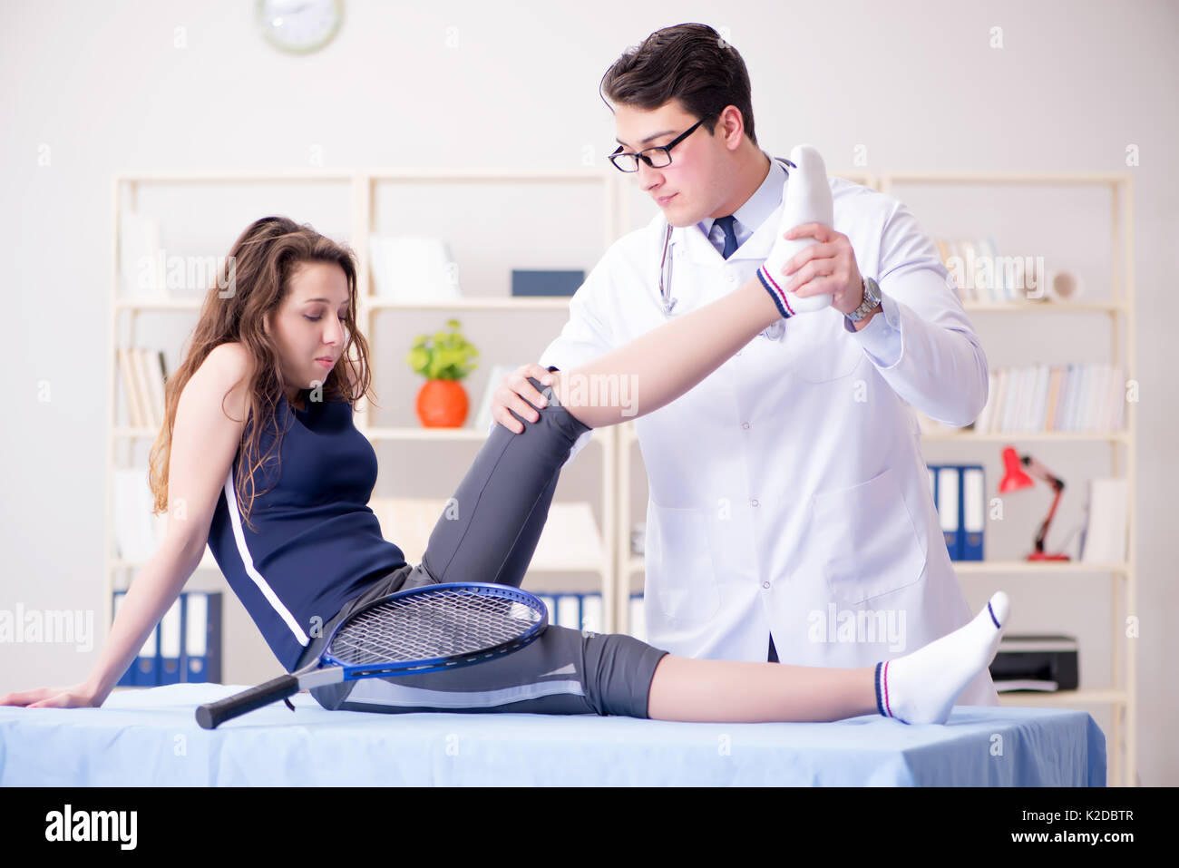 Man doctor taking care of sports injury Stock Photo - Alamy