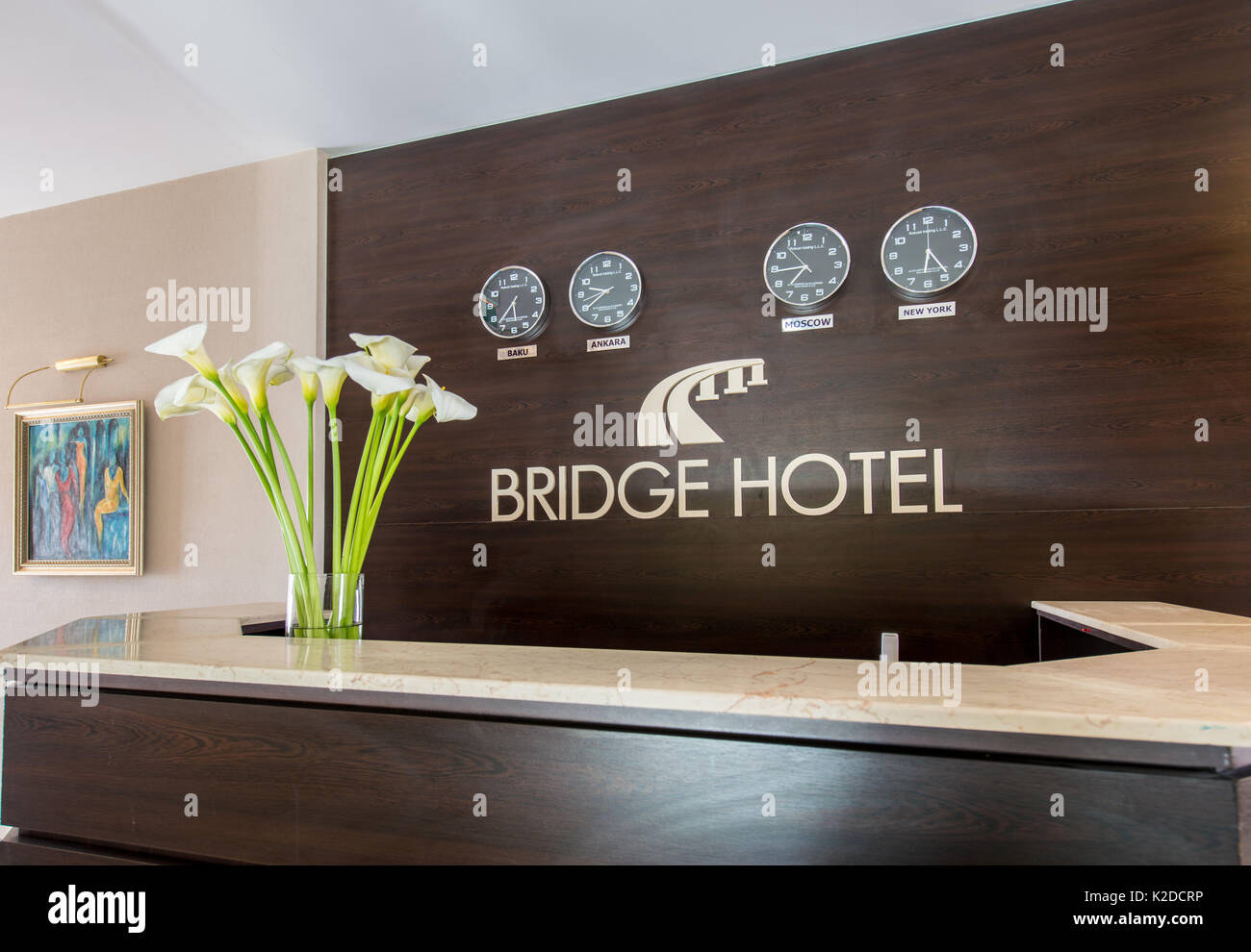 Hotel reception with desk and clocks Stock Photo - Alamy