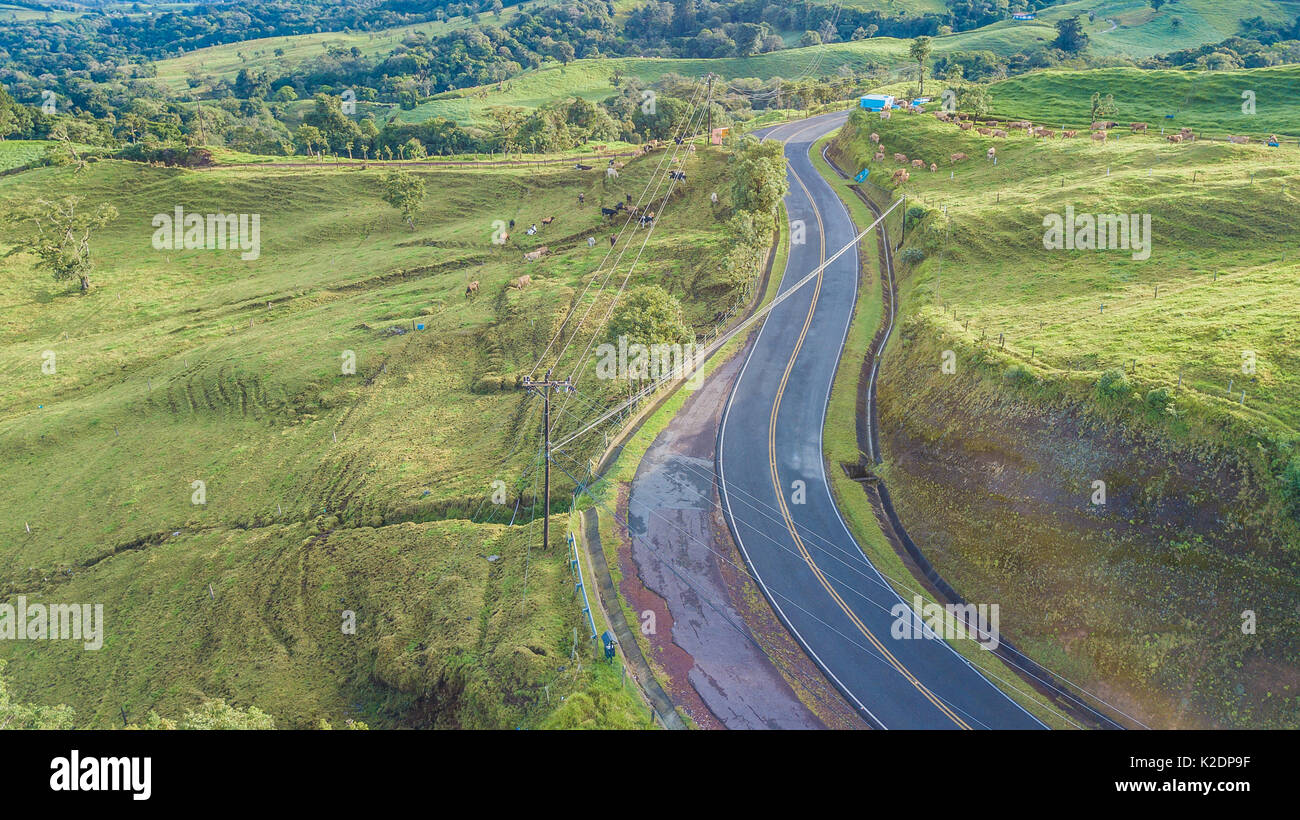 Rural road leading through green areas and farms Stock Photo - Alamy