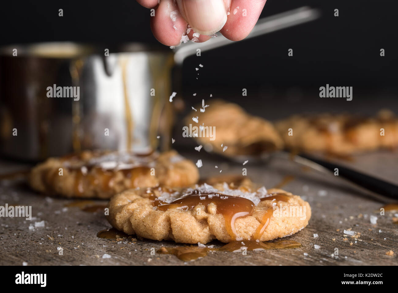 Putting the finishing touch on salted caramel cookies Stock Photo - Alamy