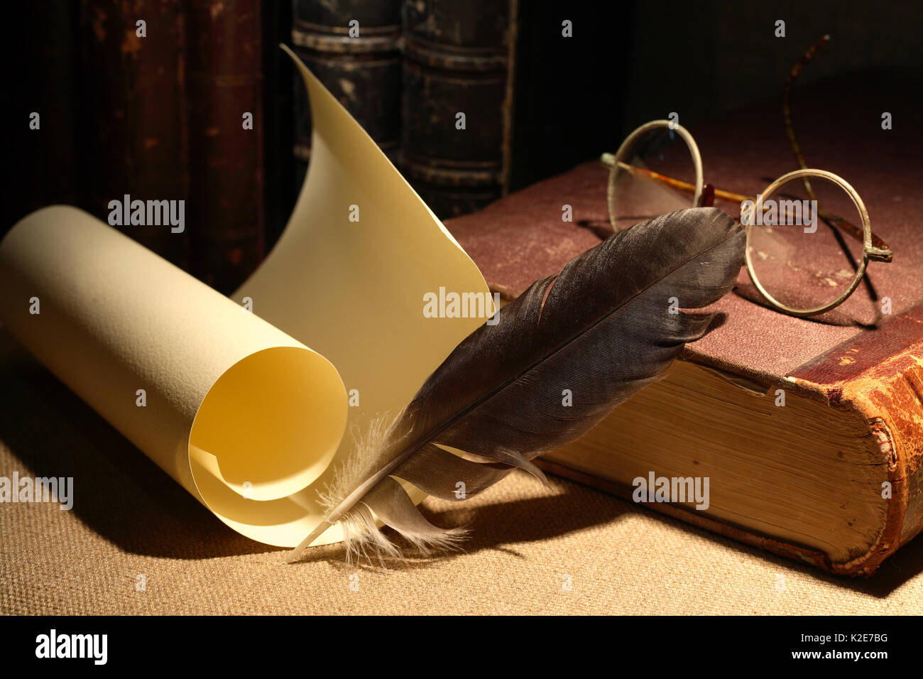 Writing concept. Vintage still life with yellow scroll and quill pen ...
