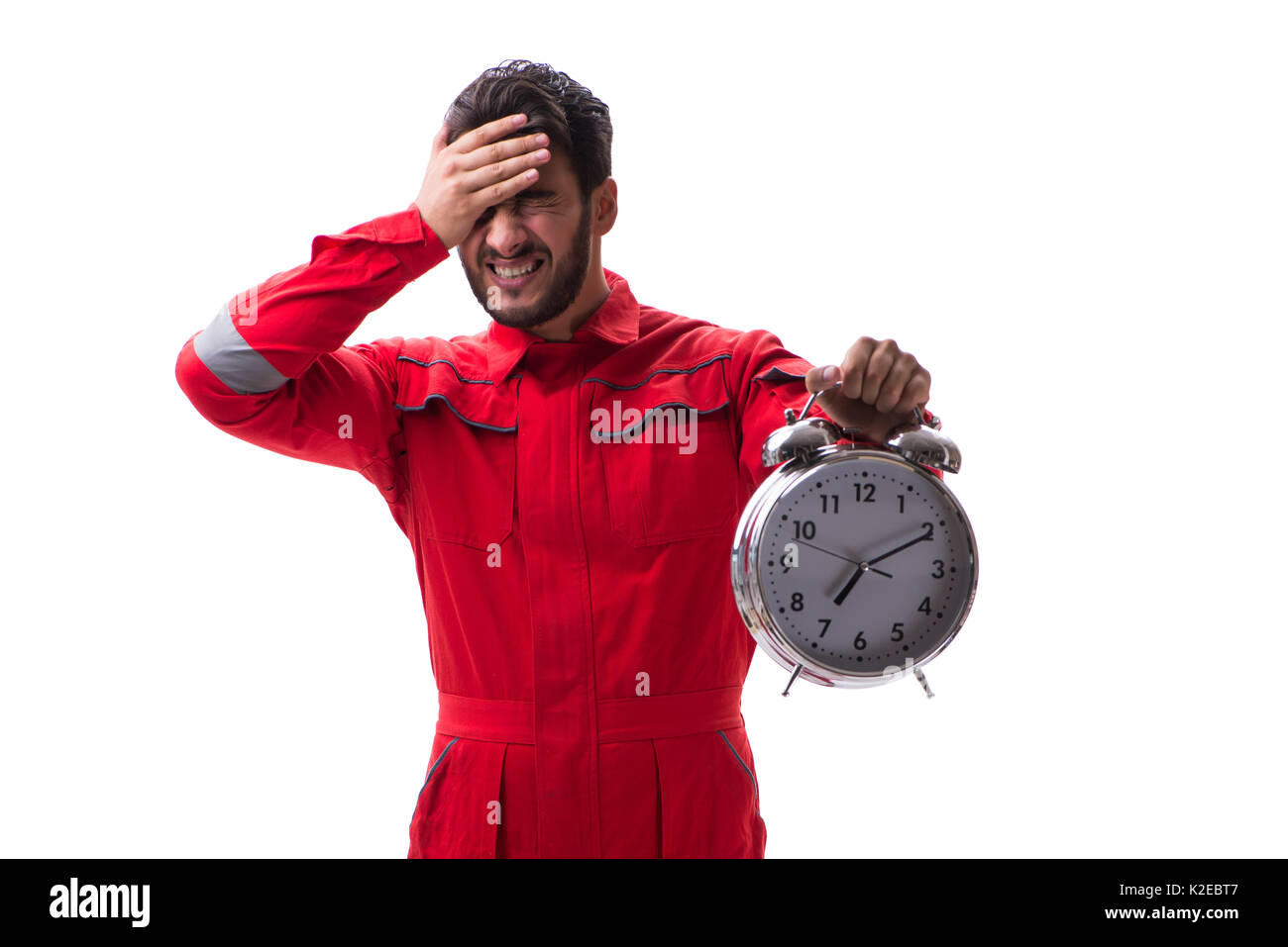 Young repairman with an alarm clock isolated on white background Stock ...