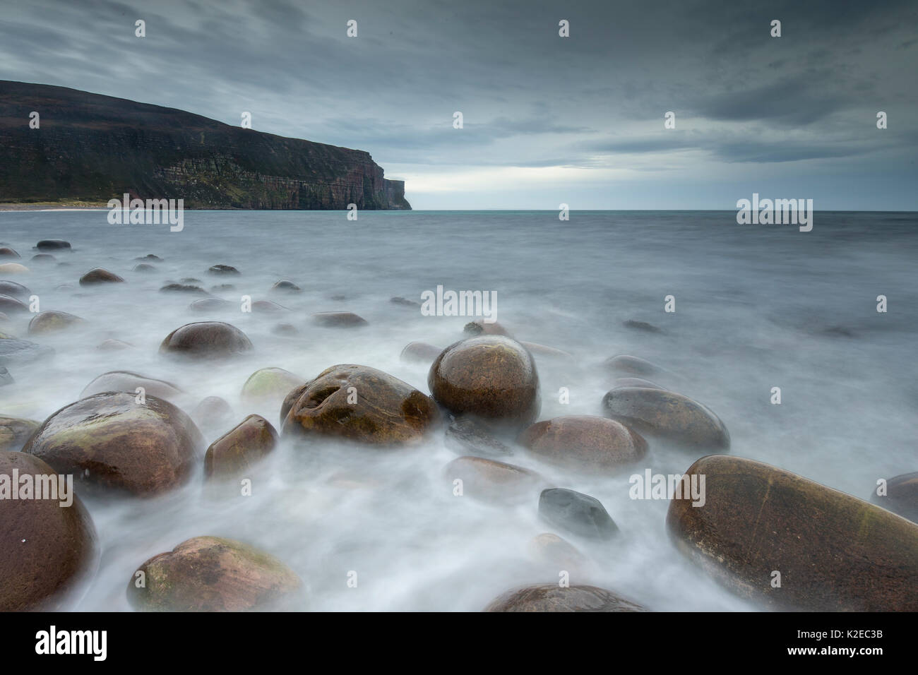 Rocks in sea at rackwick bay in stormy light hi-res stock photography ...