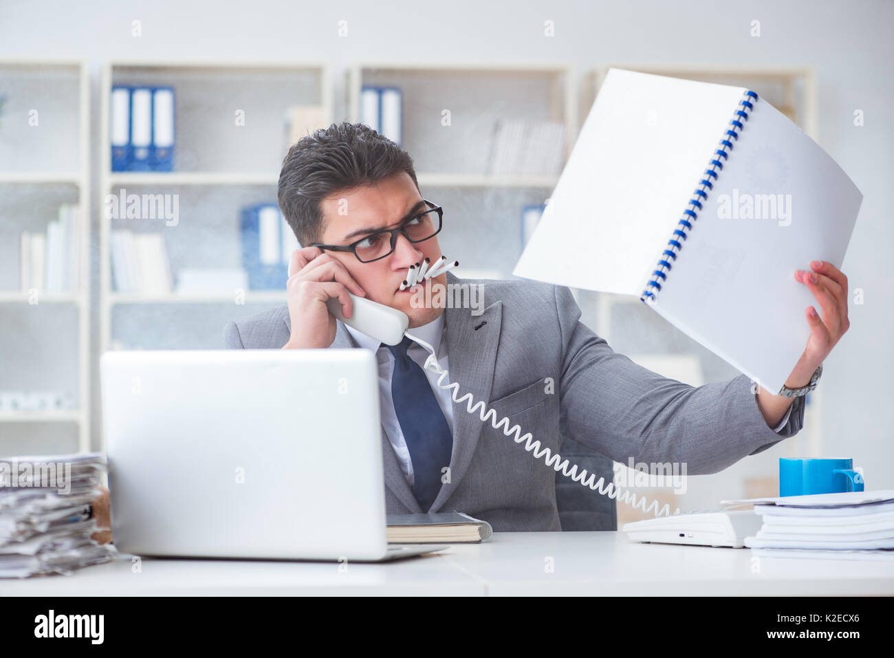 Businessman smoking in office at work Stock Photo - Alamy