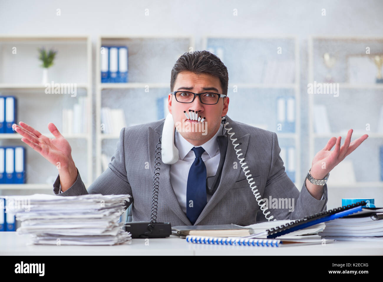 Businessman smoking in office at work Stock Photo - Alamy