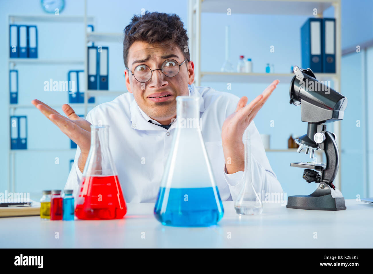 Funny mad chemist working in a laboratory Stock Photo - Alamy