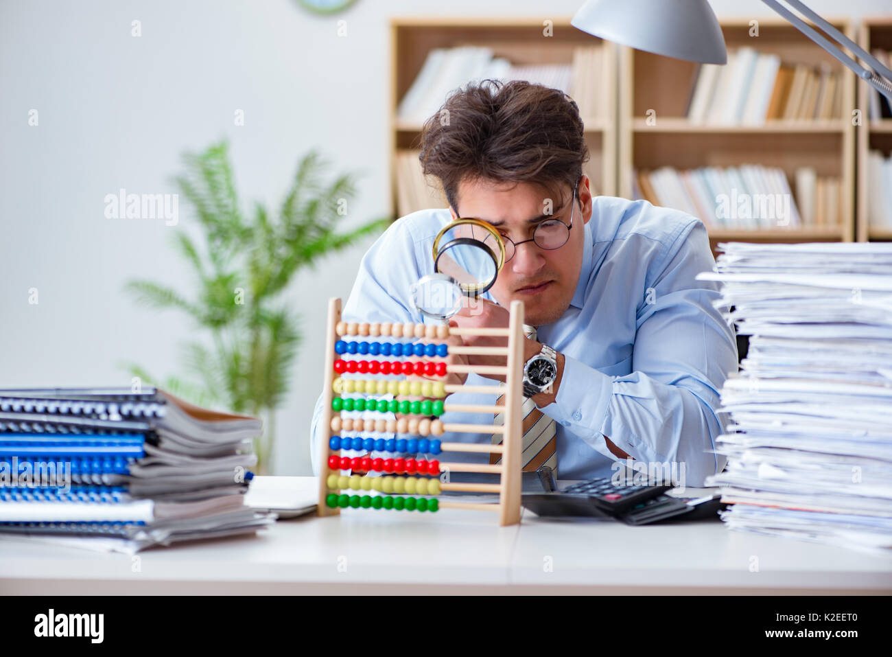 Mad auditor looking for errors in the report Stock Photo - Alamy